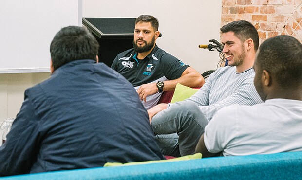 Port Adelaide players embrace Ladder